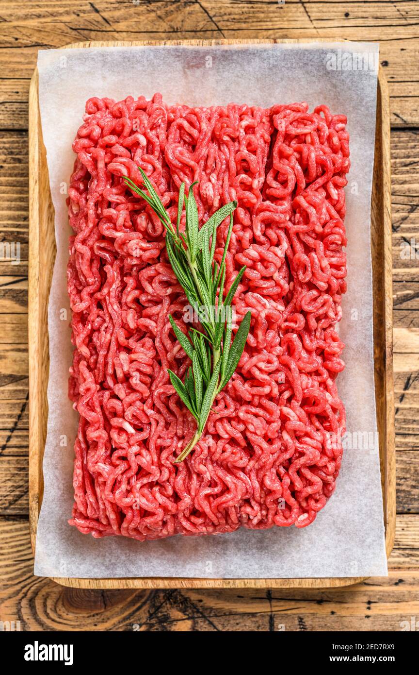 Fresh Raw mince beef, ground meat on butcher paper. wooden background ...