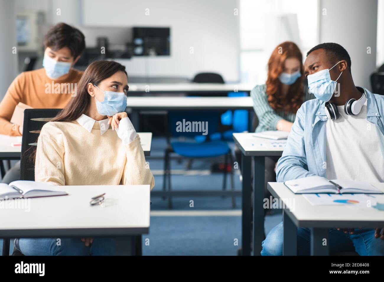 International students wearing medical masks and talking Stock Photo ...