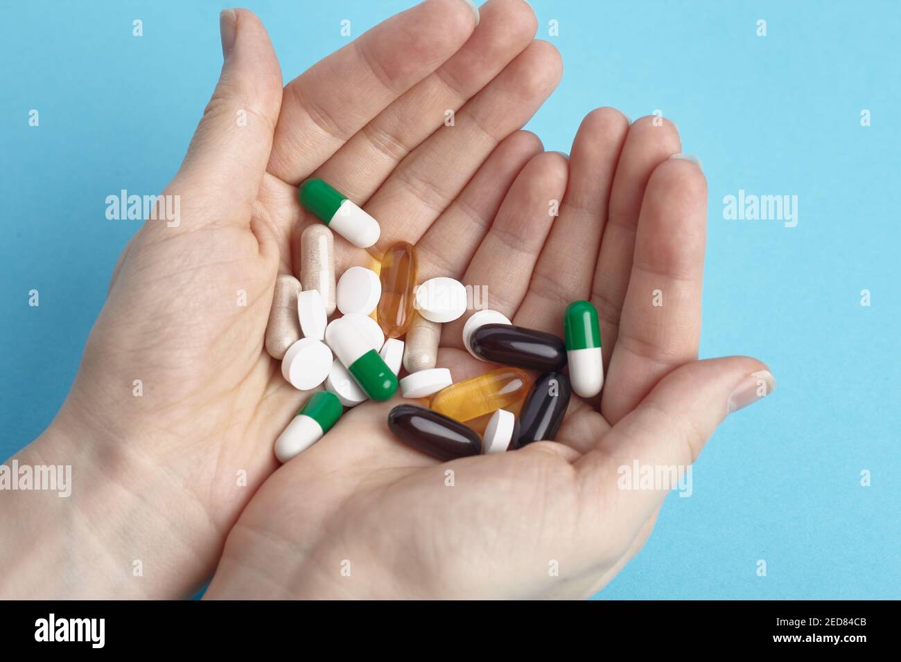 Medication in capsules hands hi-res stock photography and images - Alamy