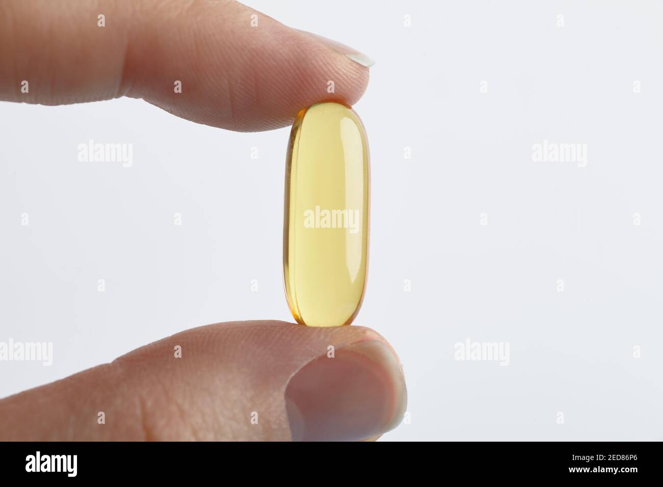Close up photo of capsule in a fingers. Heap of pills - medical ...