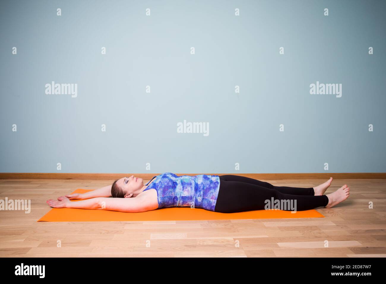Having rest on a floor deeply breathing with closed eyes Stock Photo ...