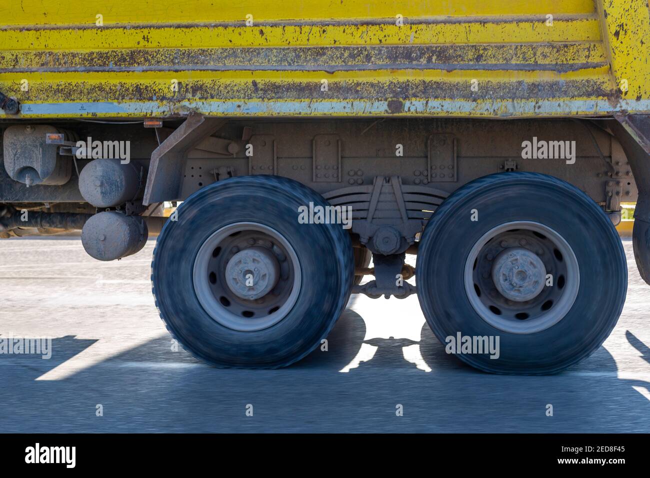 Rear wheels and axle system of a truck in motion Stock Photo - Alamy