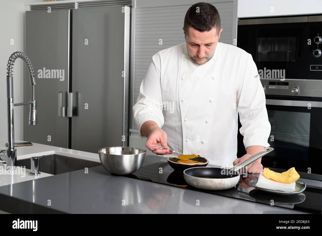 Concentrated at work. Portrait of handsome professional chef working in ...
