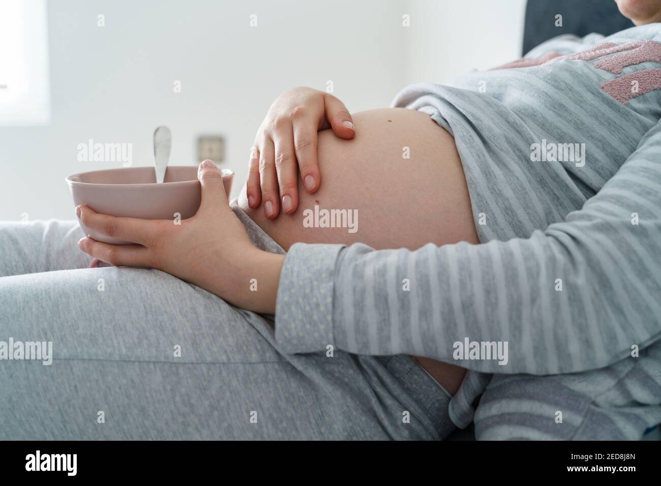 Top view on midsection of pregnant caucasian woman and belly lying on ...