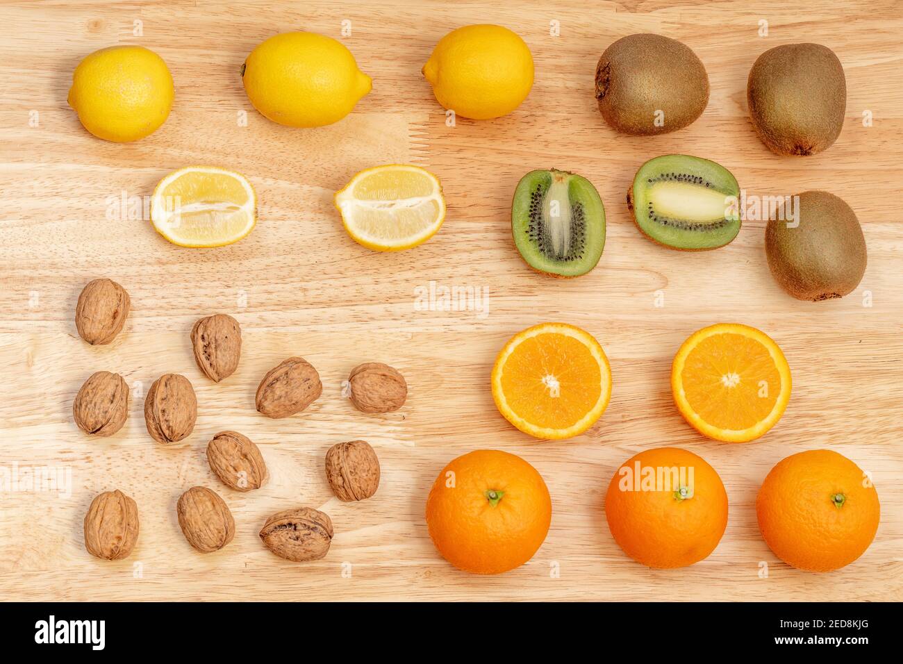 Top view of assorted fruit, lemons, oranges, kiwi fruit and nuts, whole ...