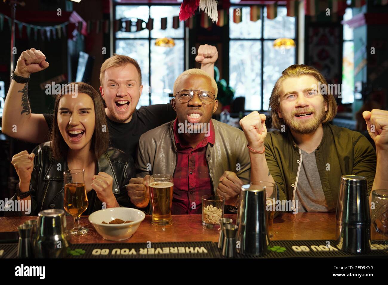 Group of young intercultural ecstatic football fans in casualwear ...