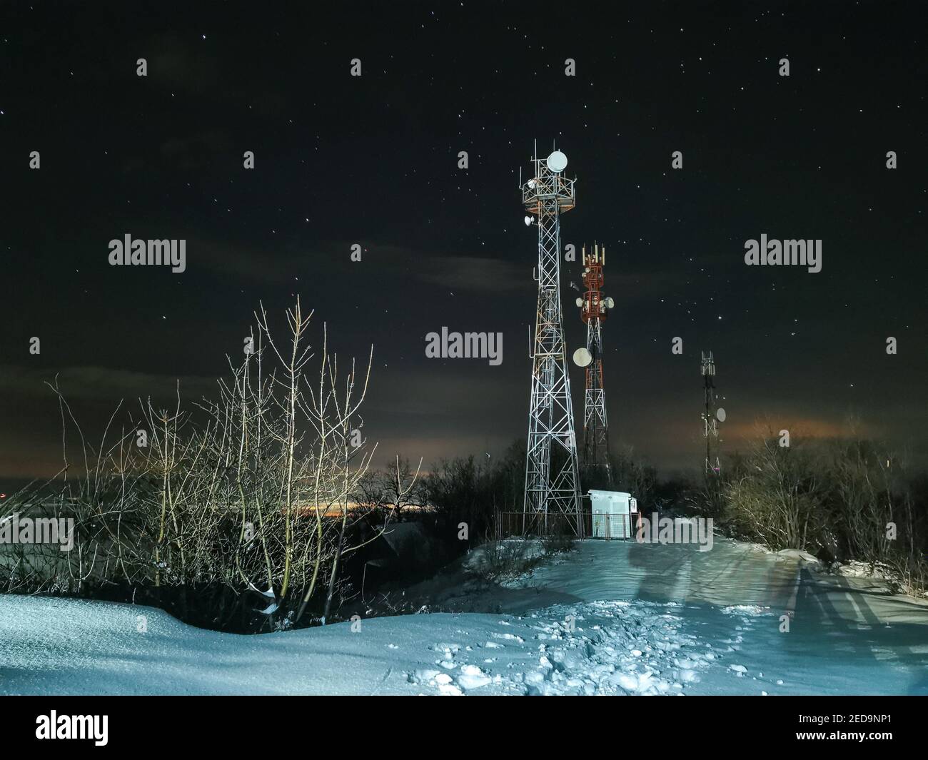 A view of tall telecommunication towers at night in winter Stock Photo ...