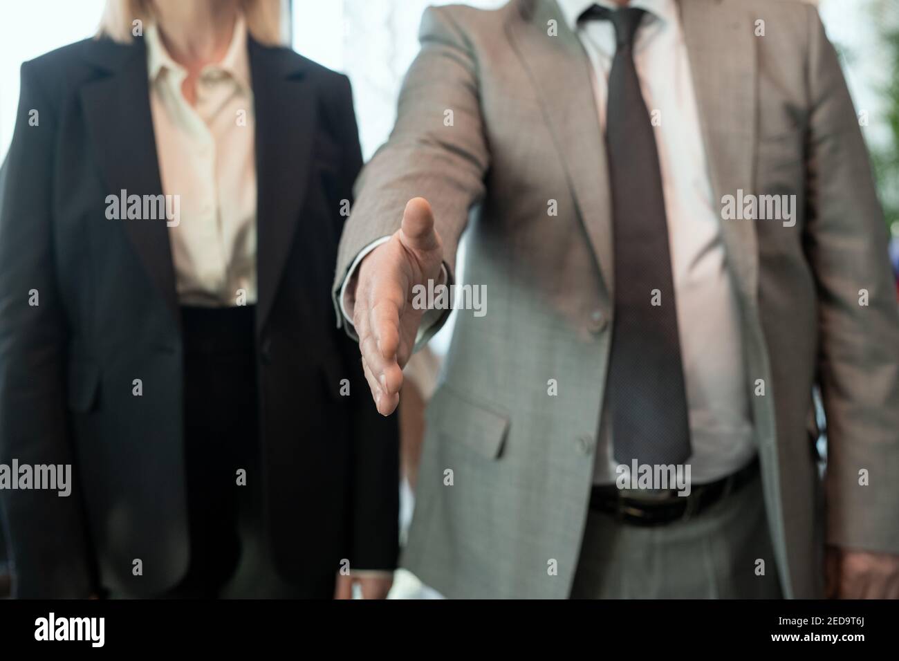 Hand of elegant mature businessman welcoming foreign partner while ...