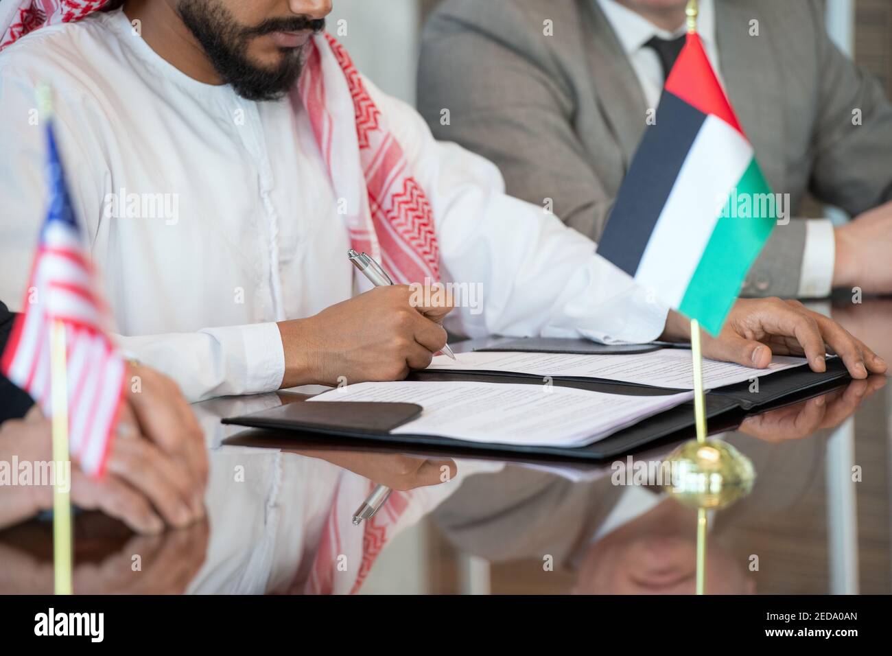 Hands of young Arabian businessman or delegate in national clothes ...