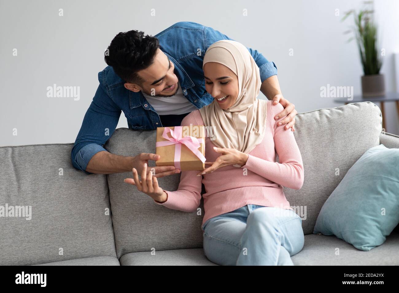 Loving middle-eastern man giving present to his happy wife Stock Photo ...