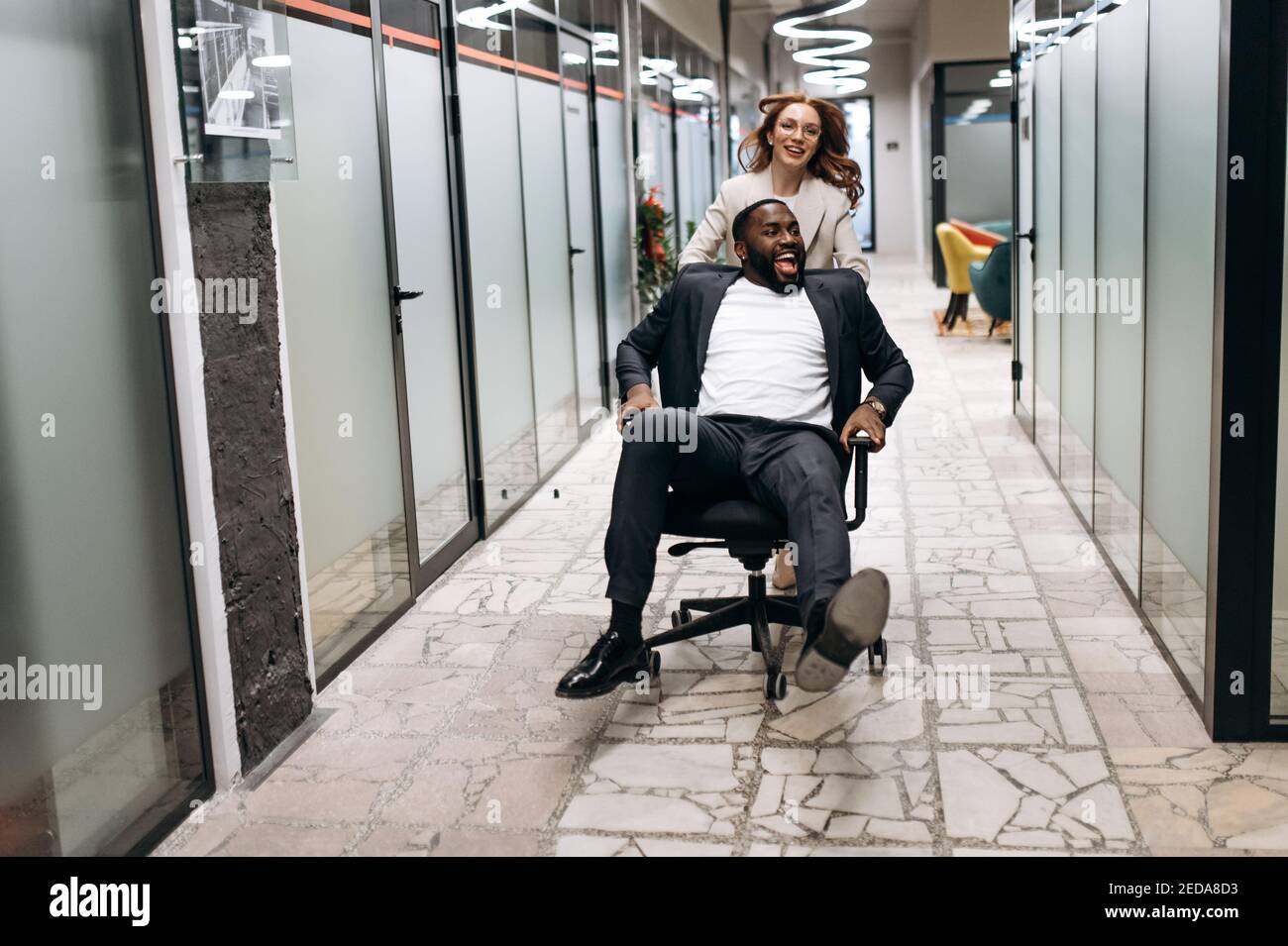 Friendly coworkers take a break from work. Caucasian woman with african ...