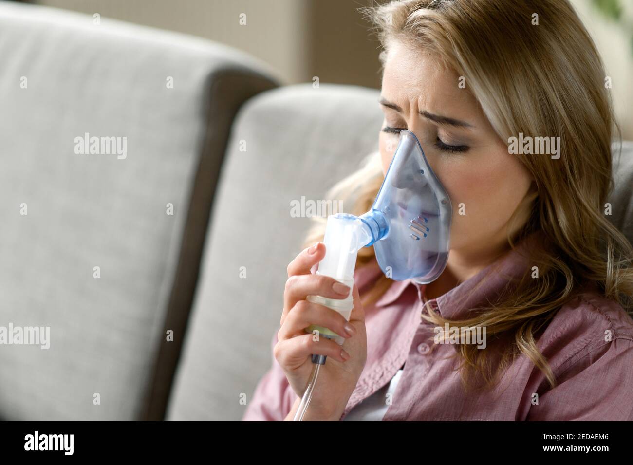Close-up photo of sick caucasian woman with an inhaler. Unhealthy ...