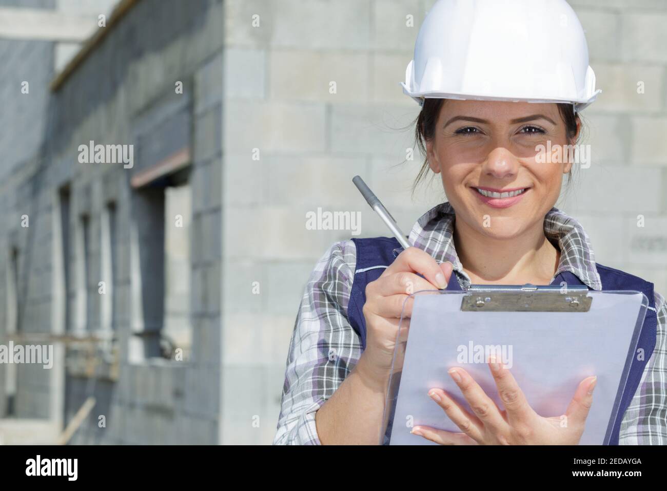 engineer checking clipboard in construction site Stock Photo - Alamy