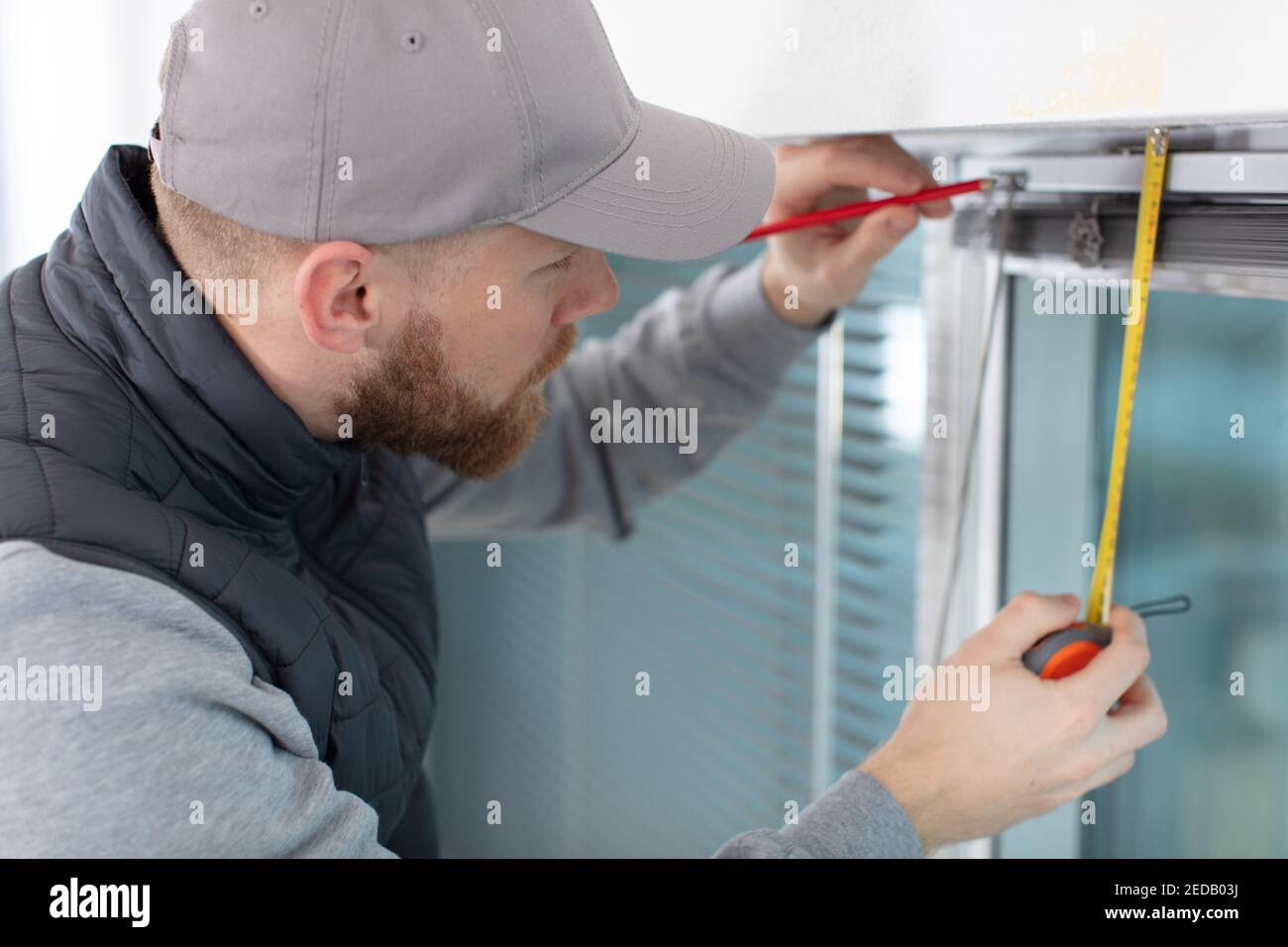 young man installing window shades at home Stock Photo - Alamy