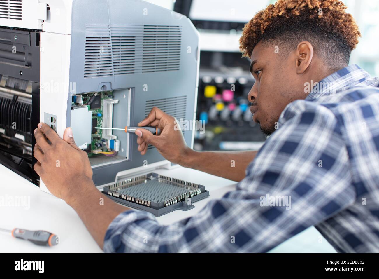 a focused technician repairing a machine Stock Photo - Alamy
