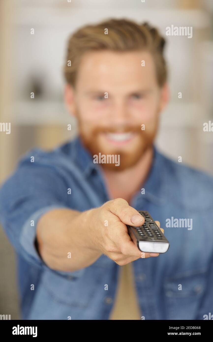man uses a remote control while watching tv Stock Photo - Alamy