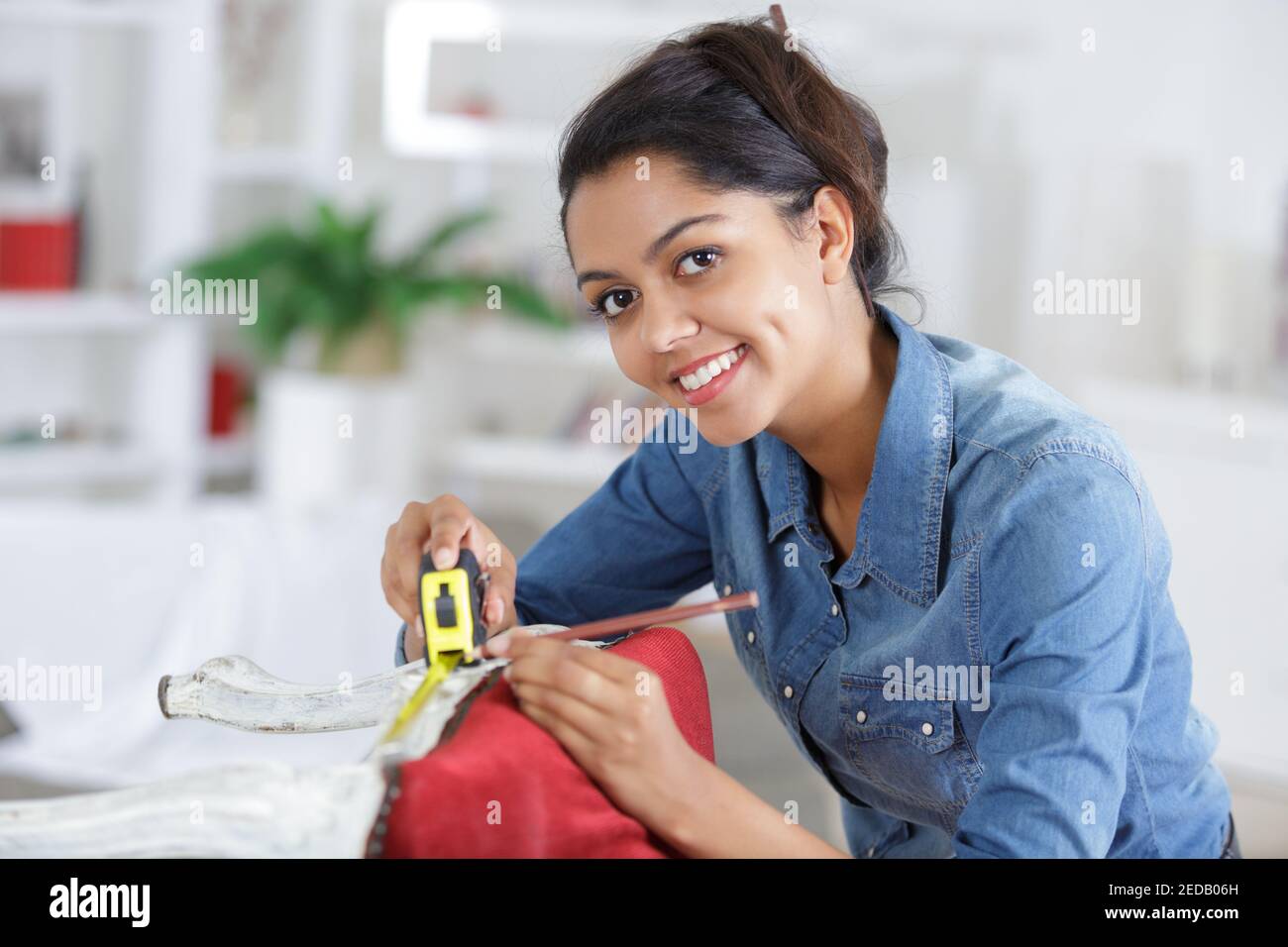 Woman measuring chair before hi-res stock photography and images - Alamy
