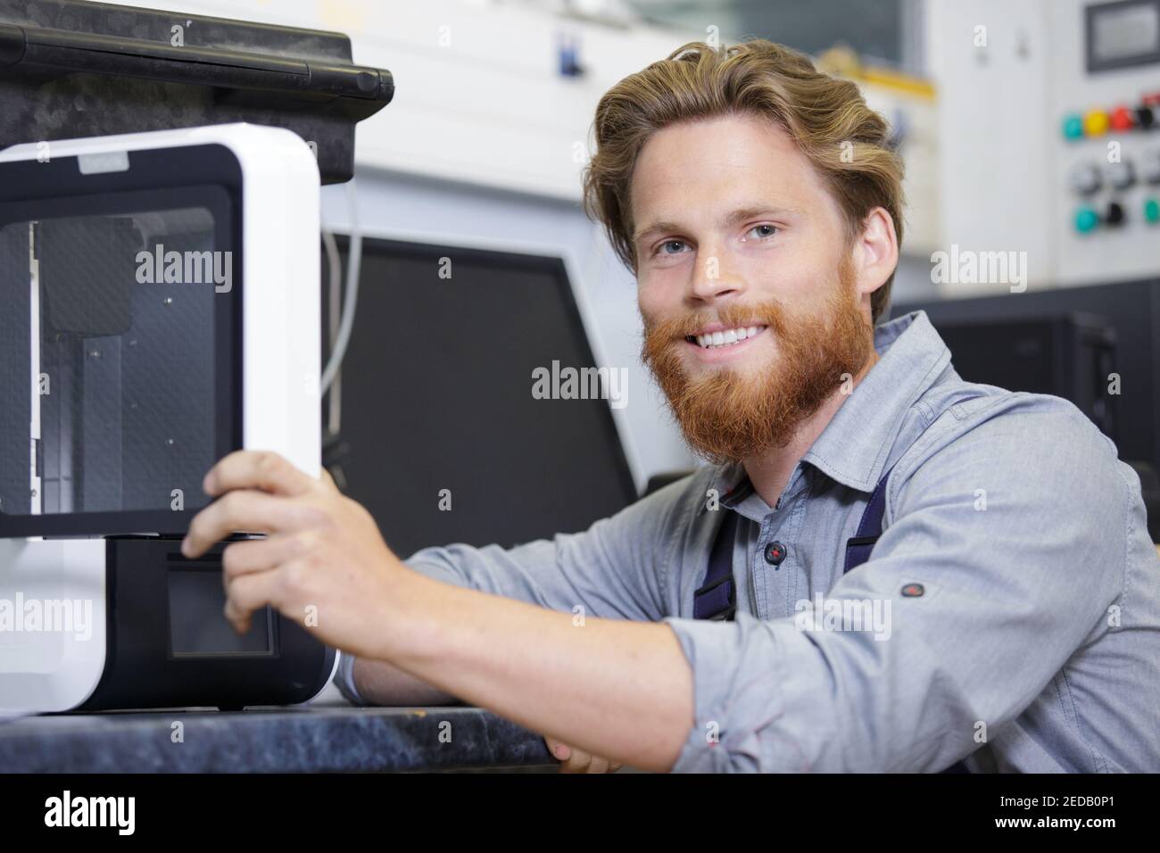 happy worker using machine in a factory Stock Photo - Alamy