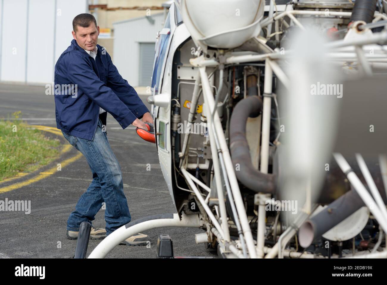 mechanic moving light aircraft at airfield Stock Photo - Alamy