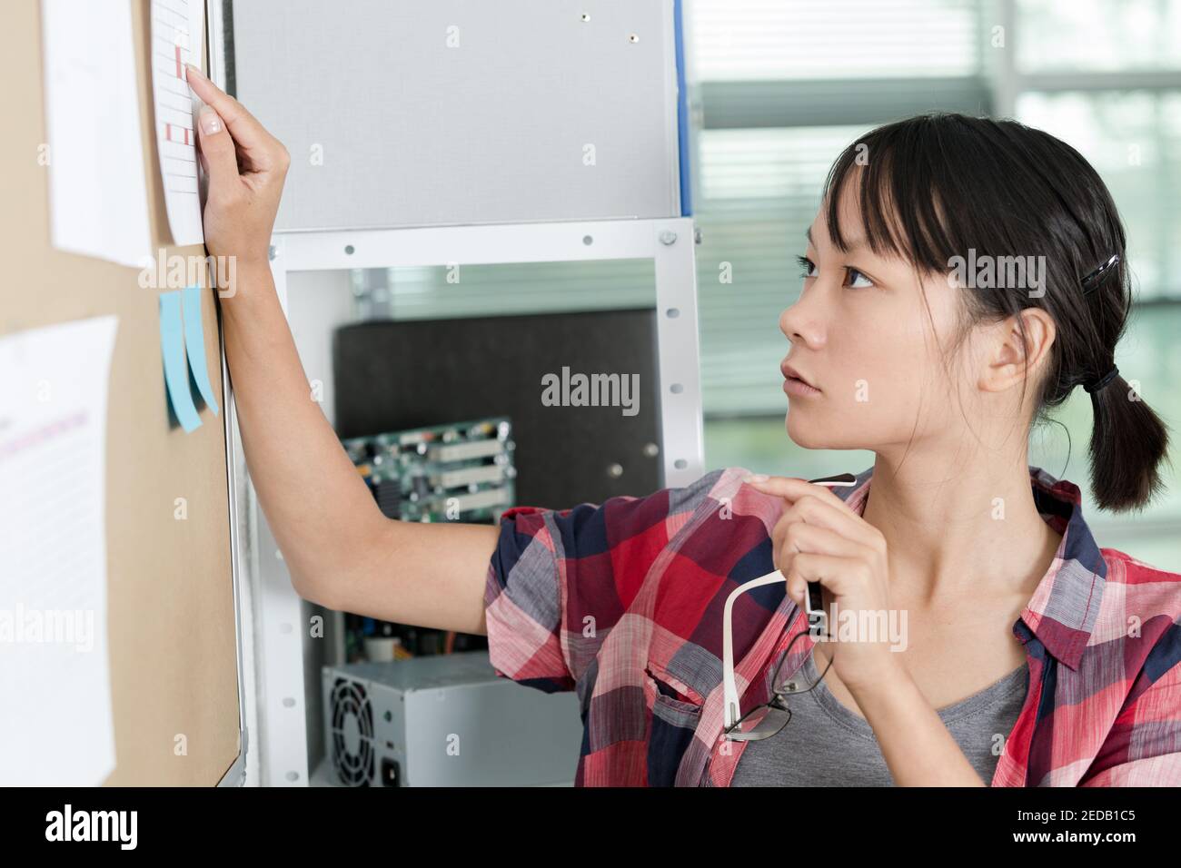 female asian architect smiling to camera in open plan office Stock ...