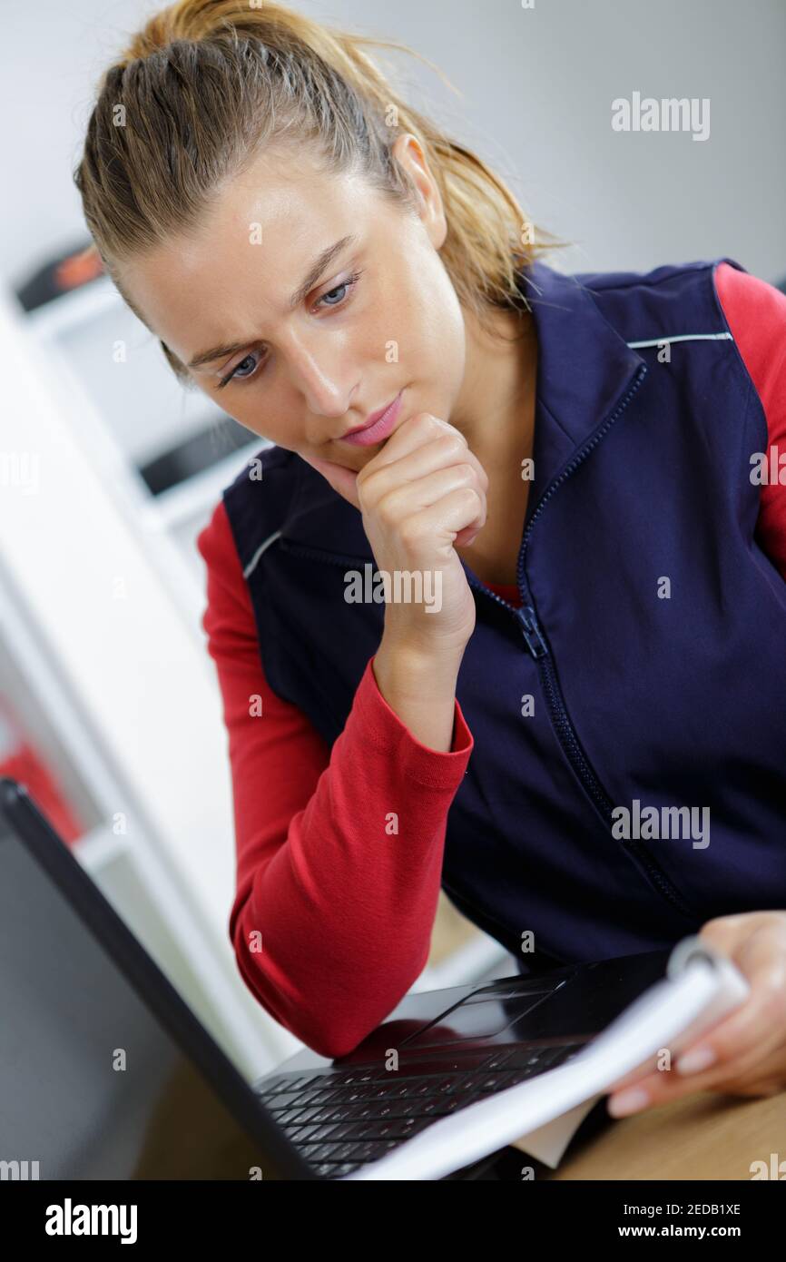 a female worker reading booklet Stock Photo - Alamy