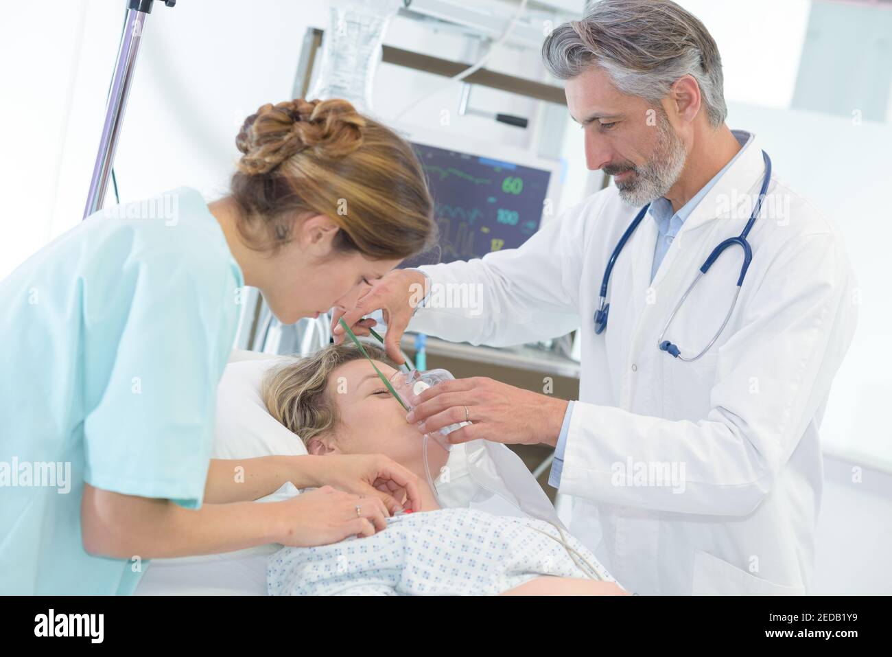 doctors examine female patient in hospital Stock Photo - Alamy