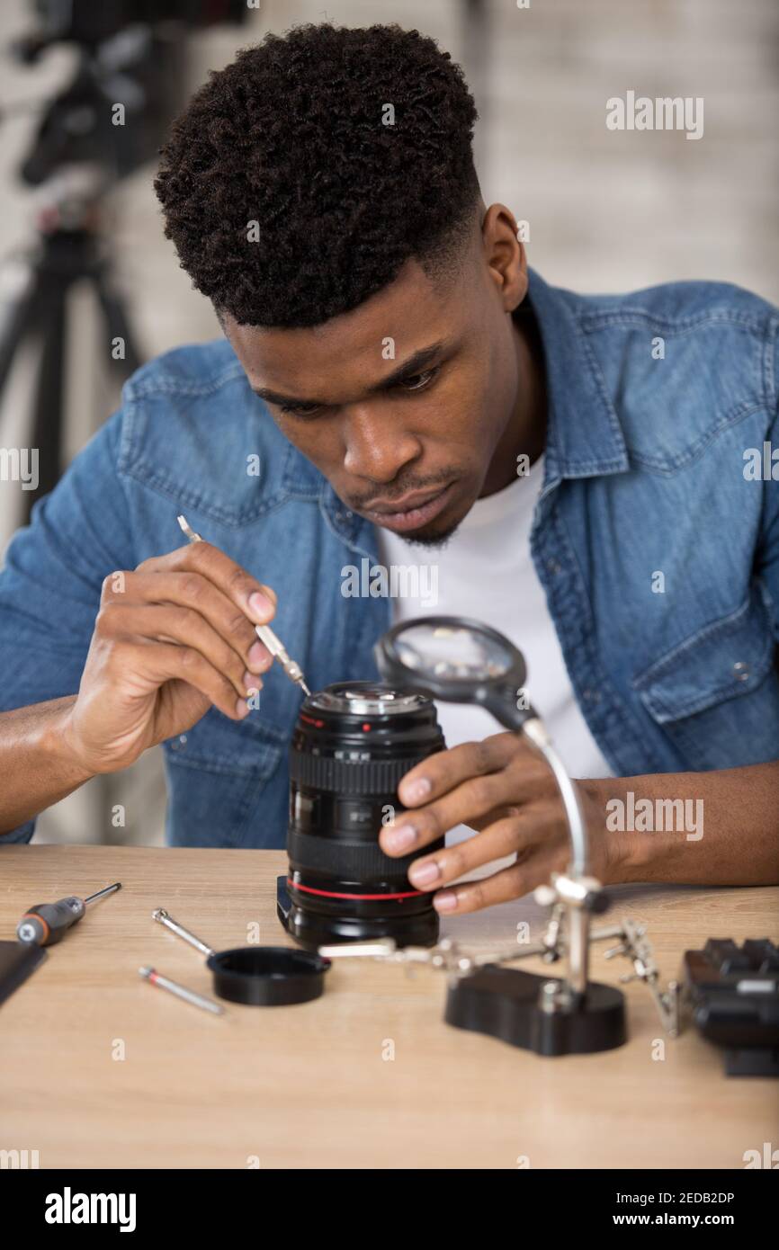 the photographer is cleaning his camera by himself Stock Photo - Alamy