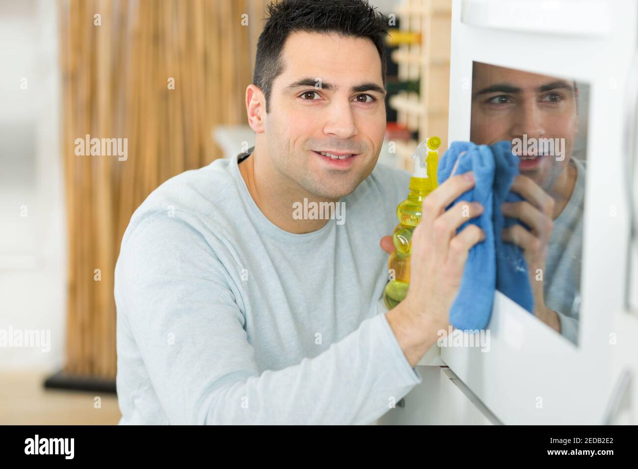 man cleaning oven carfully Stock Photo - Alamy