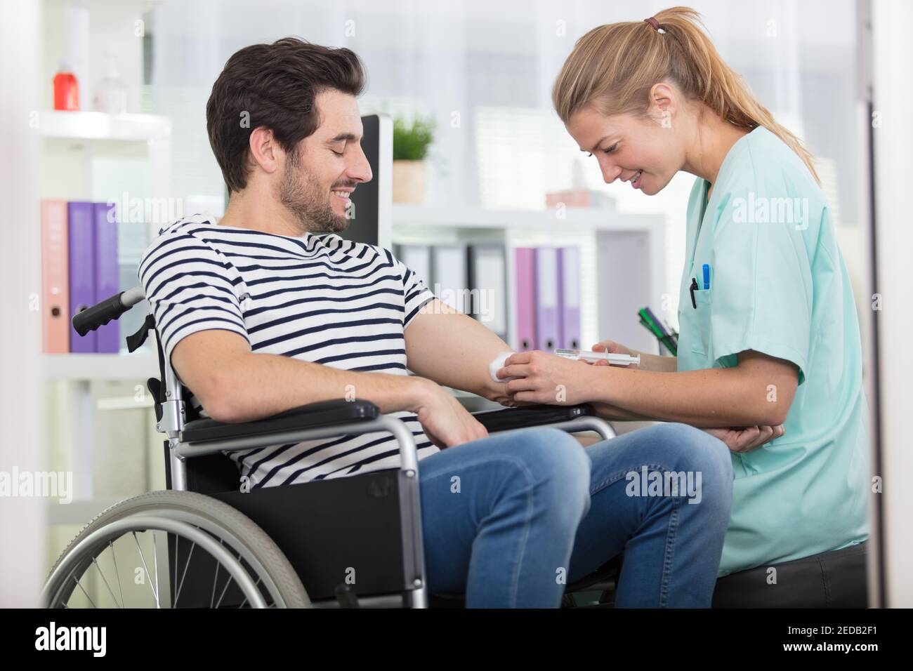 positive doctor and patient on wheelchair Stock Photo - Alamy