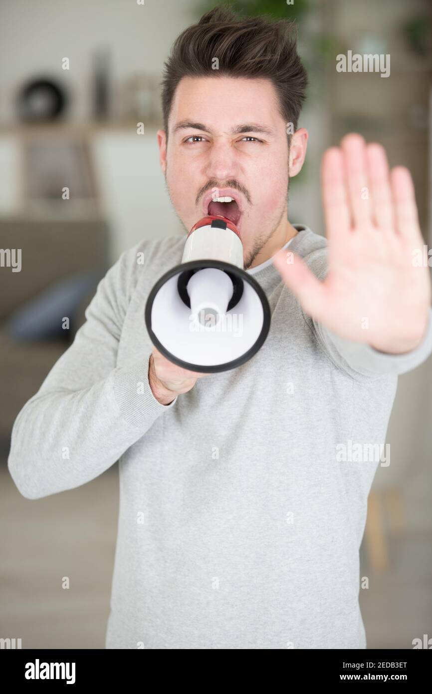 young man shouting on megaphone Stock Photo - Alamy