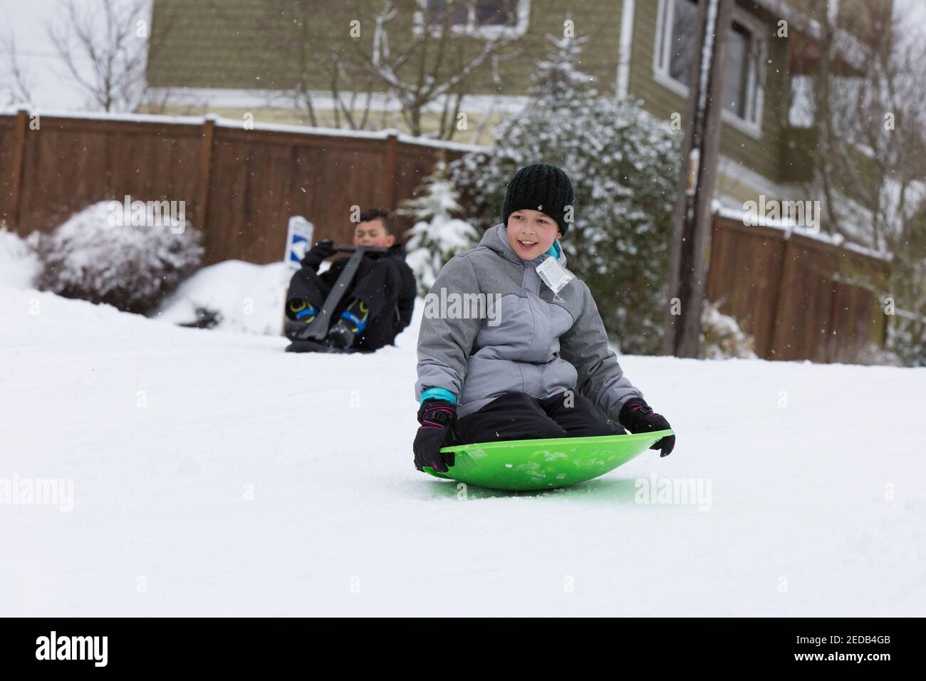 Seattle, Washington, USA. 14th February, 2021. Kids enjoy sledding down ...