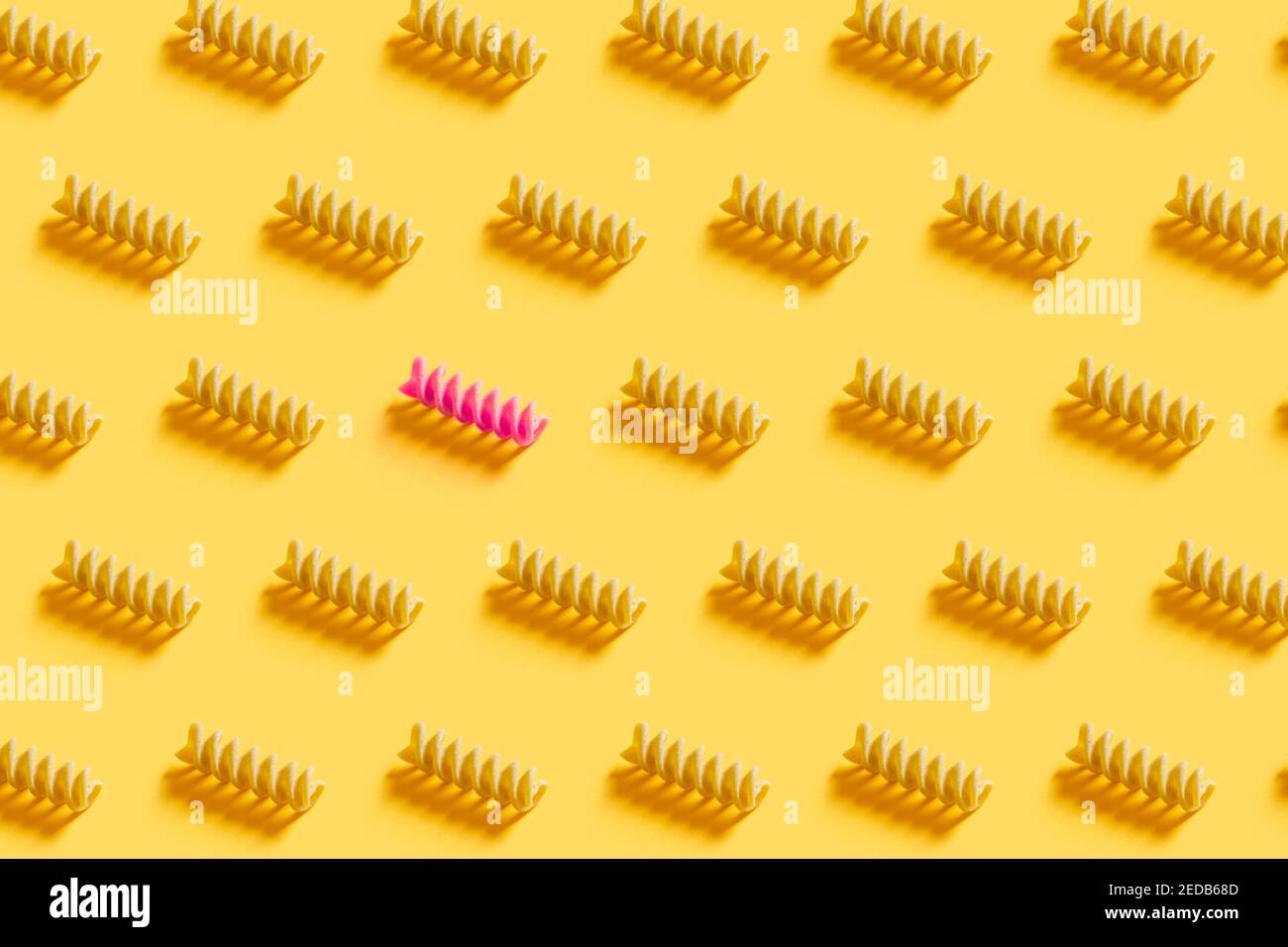 Wholegrain and healthy Italian pasta pattern with pink macaroni on a ...