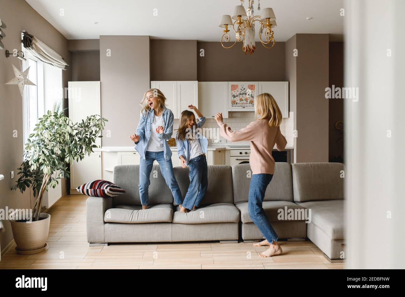 Happy three generations. Cheerful caucasian mom daughter and modern ...