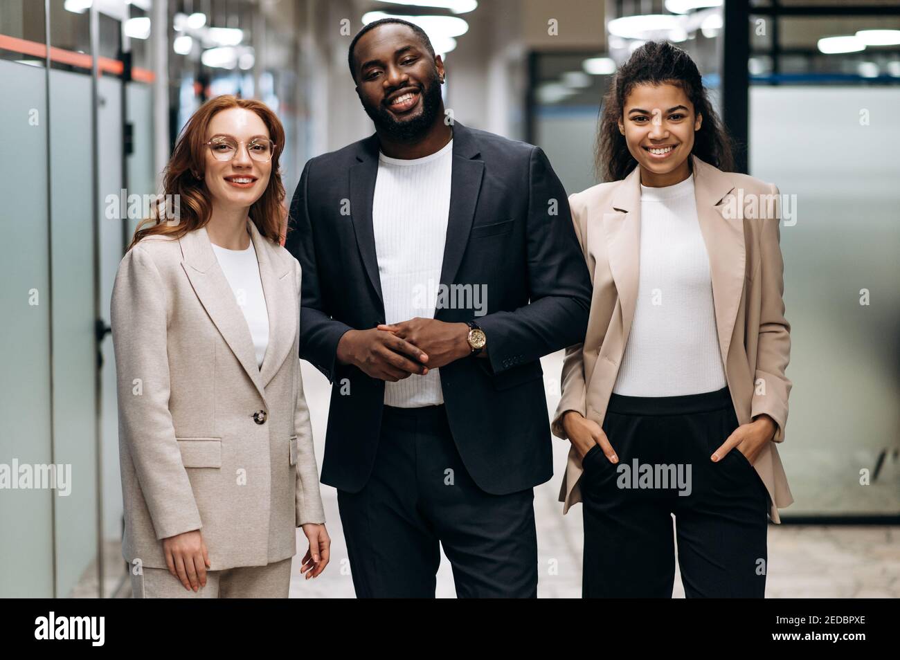 Confident successful colleagues stand in modern office. Portrait of ...