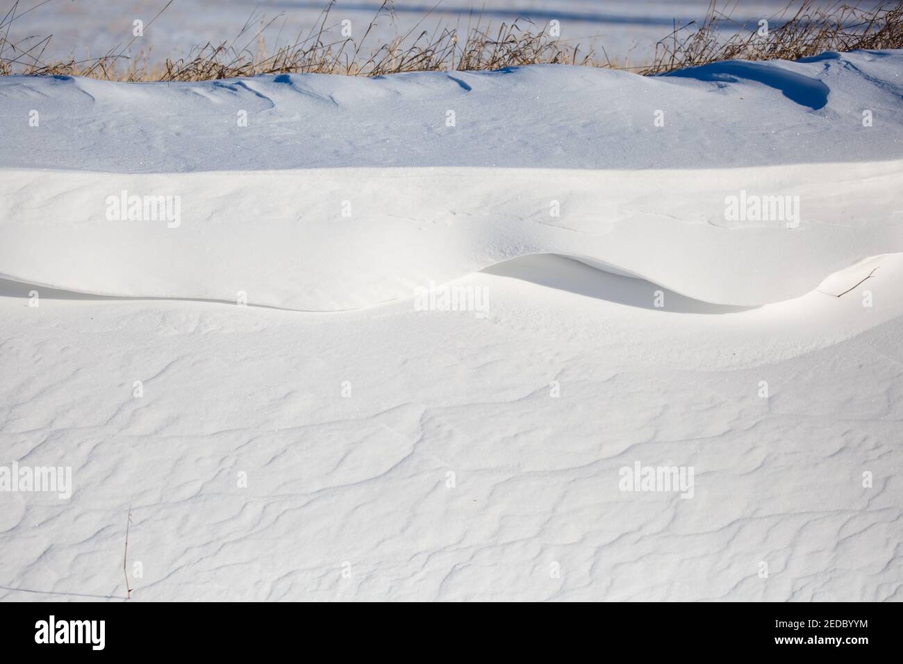 Close-up of snow wave patterns caused by wind, horizontal Stock Photo ...