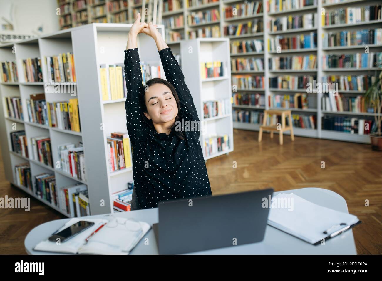 Confident young lady relax at the workplace. Happy female employee sit ...