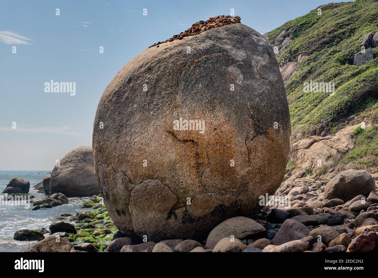 Tourist big stone with some small stones on the top Stock Photo - Alamy