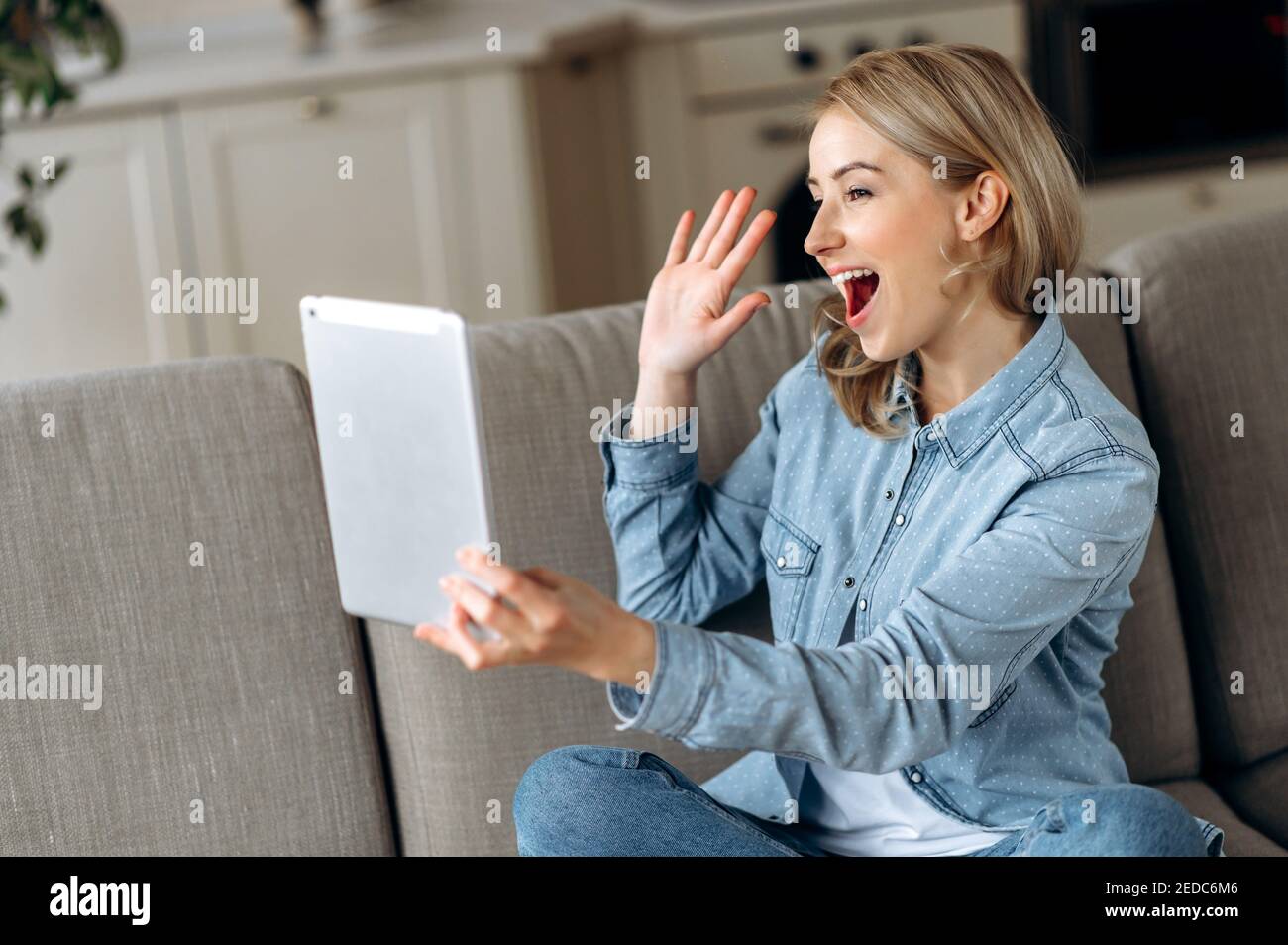 Online video conference. Cheerful caucasian blonde communicates by a ...