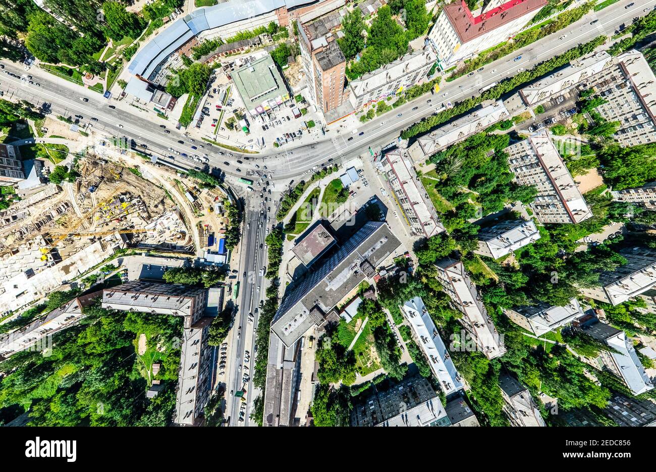 Aerial city view with crossroads and roads, houses, buildings, parks ...