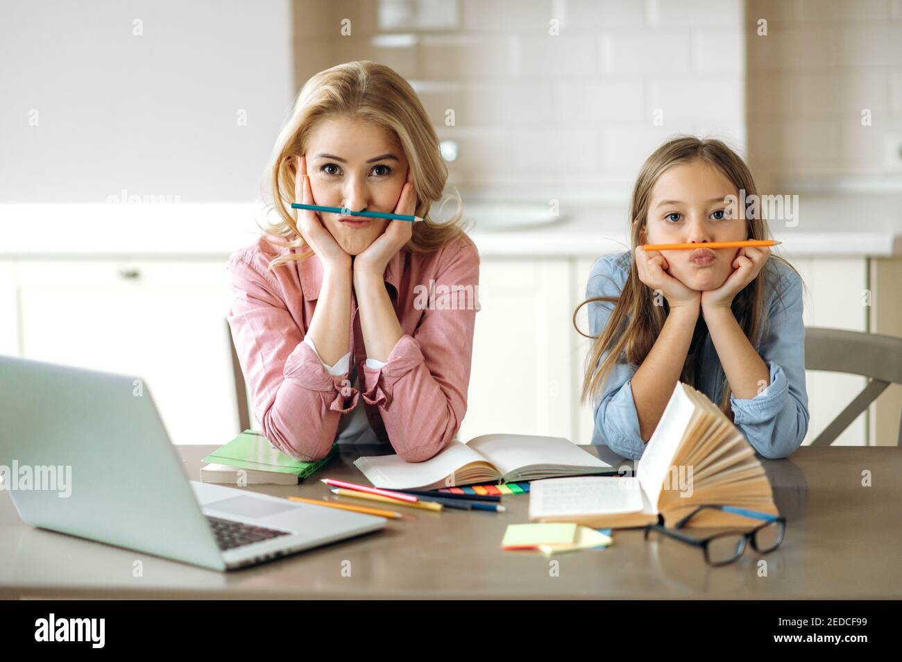 Distance learning. Mom helps her daughter do her homework, they are ...