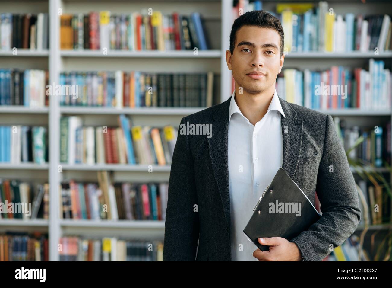 Portrait of hispanic man in formal wear at the workplace. Successful ...