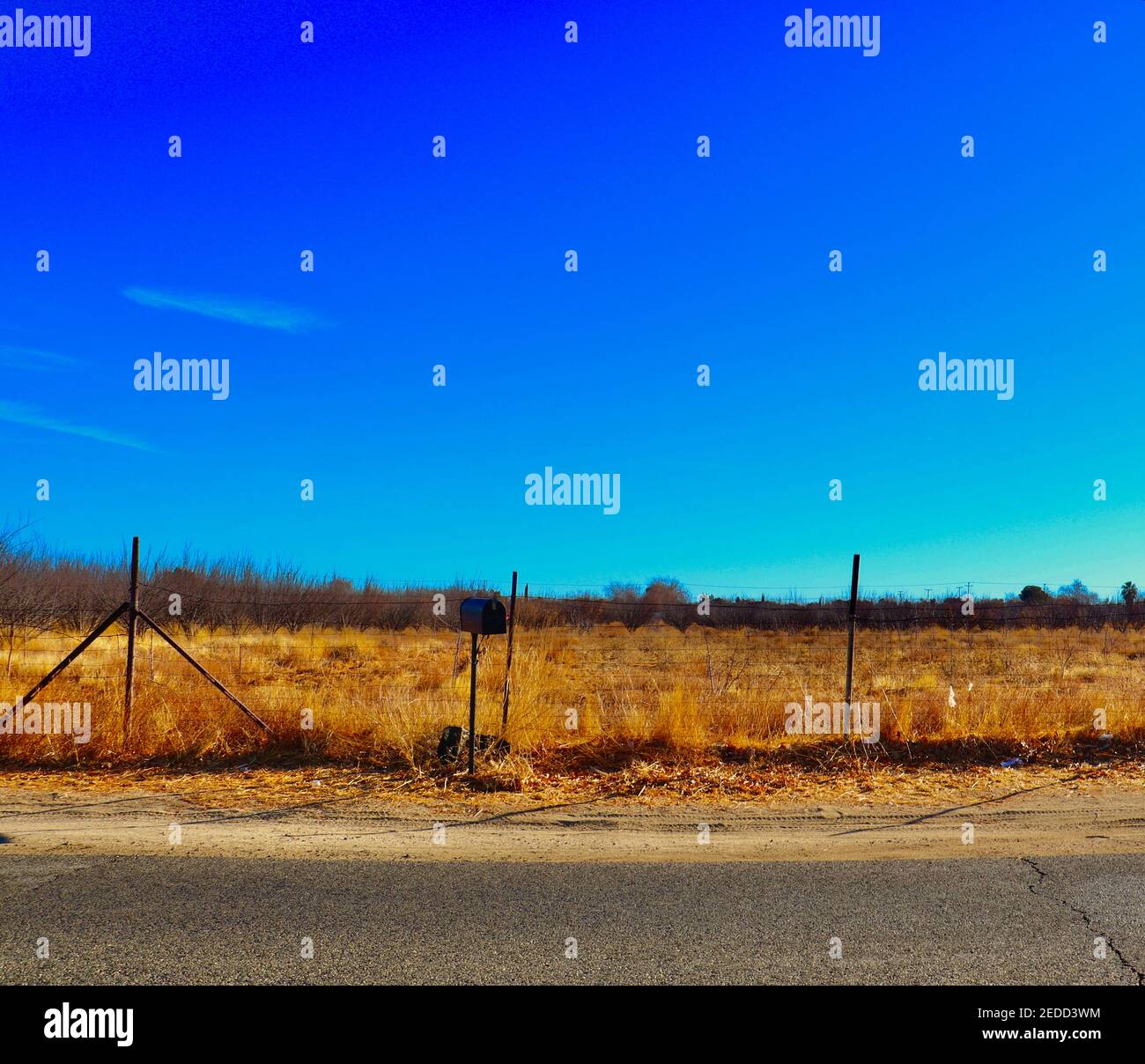 Rustic fence with rural desert landscape Stock Photo - Alamy
