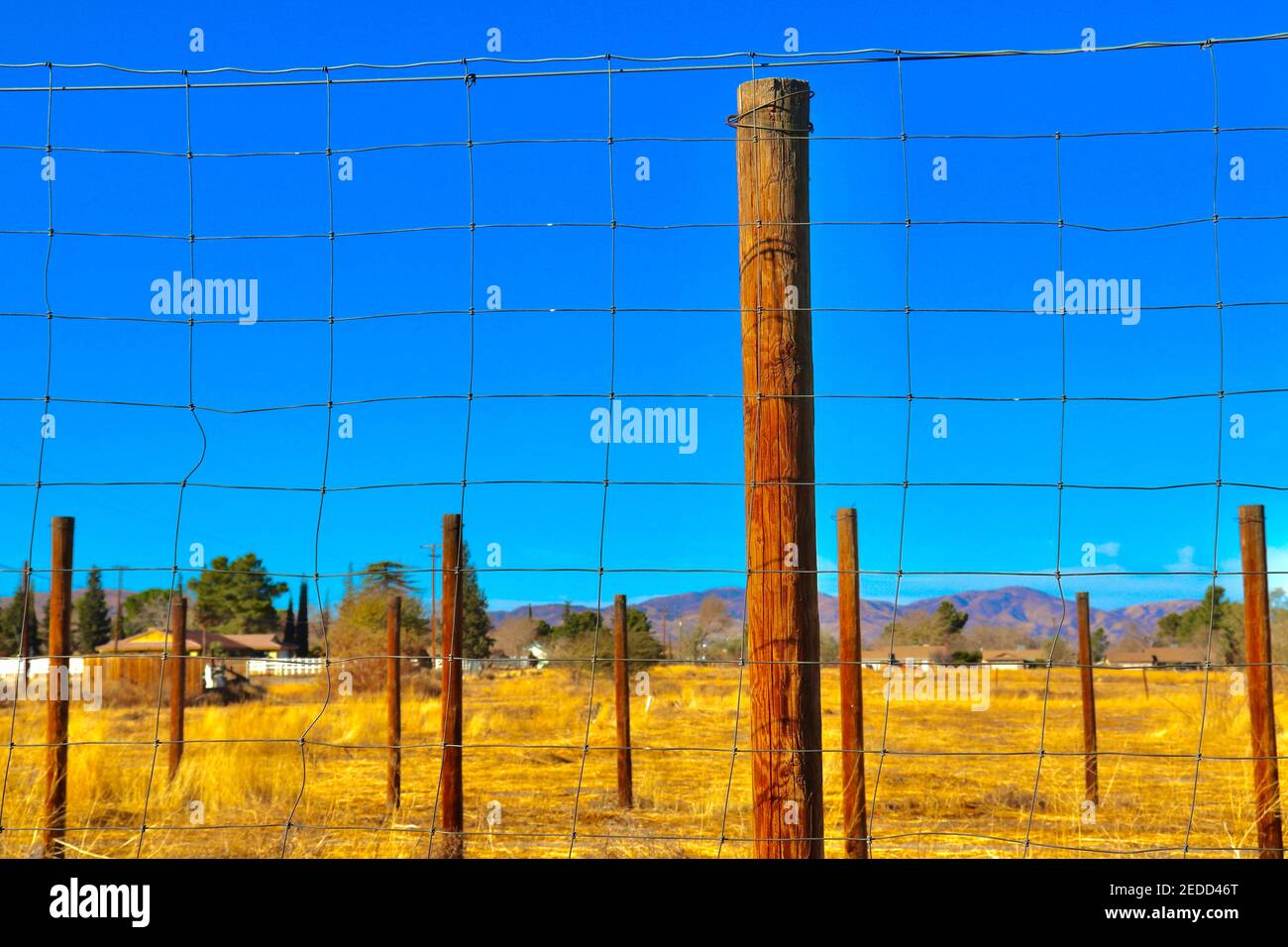 Rustic fence with rural desert landscape Stock Photo - Alamy