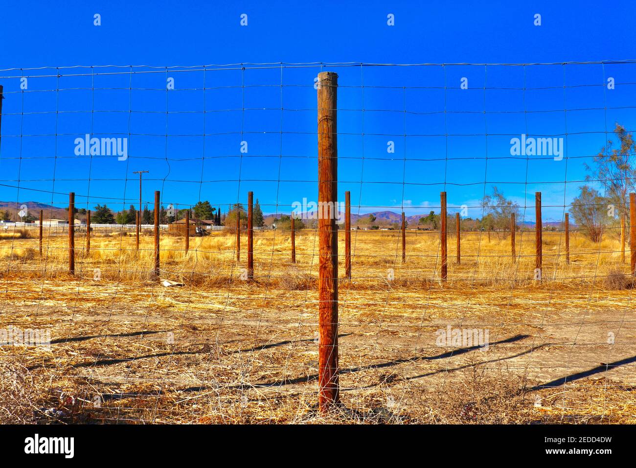 Rustic fence with rural desert landscape Stock Photo - Alamy