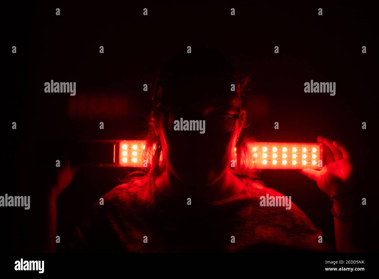 woman with dark background and scary red light Stock Photo - Alamy