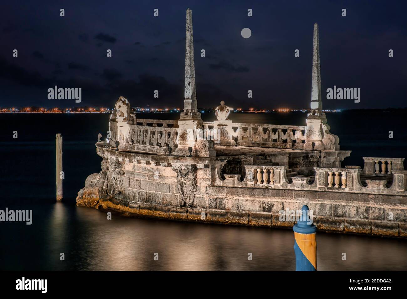 The moon shines over the Stone Barge breakwater at Villa Vizcaya in ...