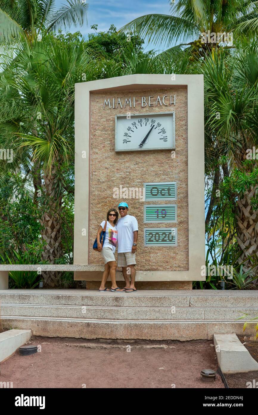 Tourist couple pose in front of Miami Beach sign on South Beach updated ...