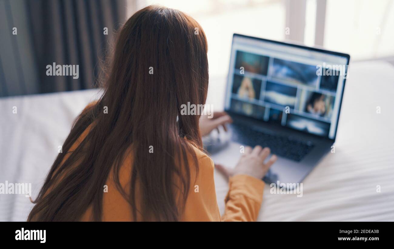 woman lying in bed in front of laptop working at home internet Stock ...
