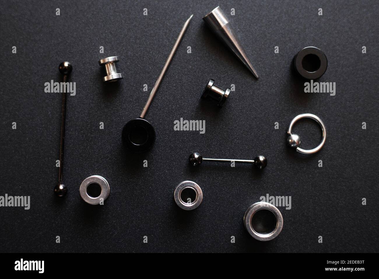metal piercing on dark gray background closeup Stock Photo - Alamy