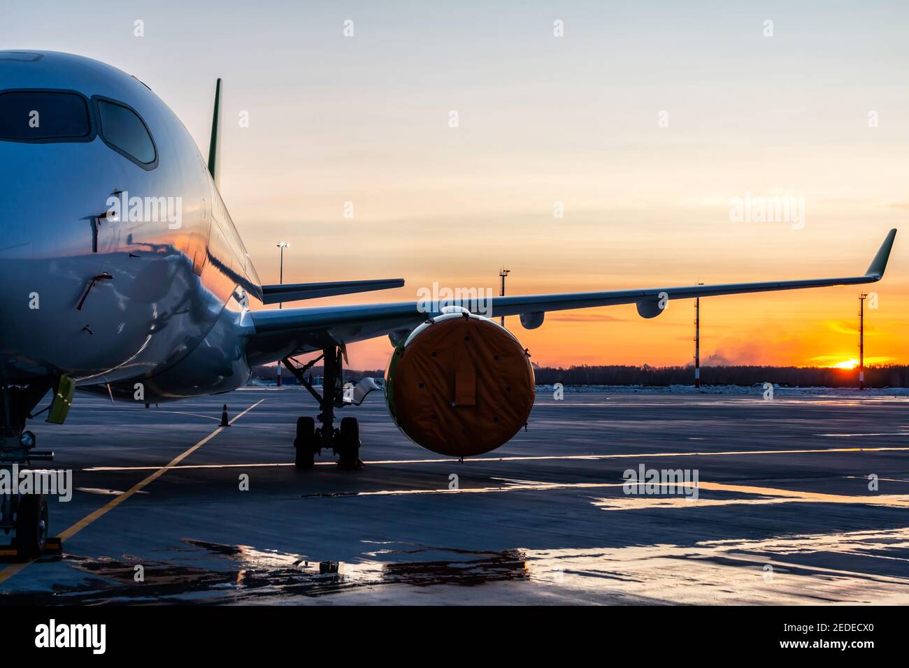 Modern passenger aircraft on the apron of the airport against the ...
